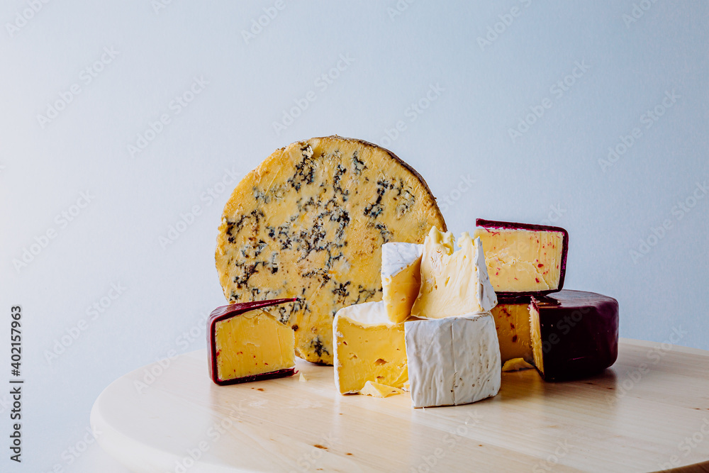 Assortment of different cheese types on dark and white background ...