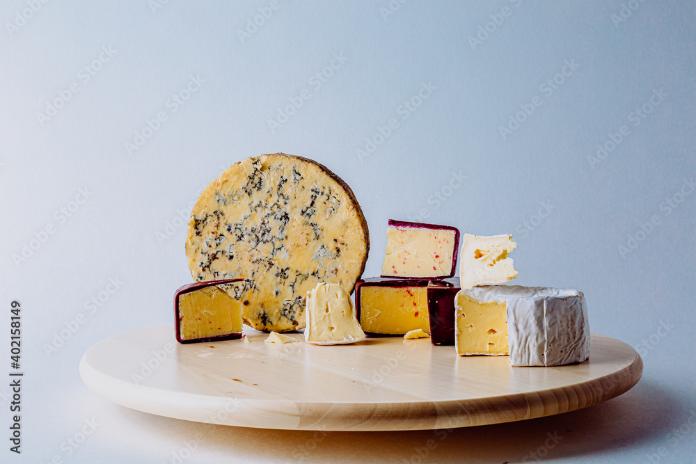 Assortment of different cheese types on dark and white background ...