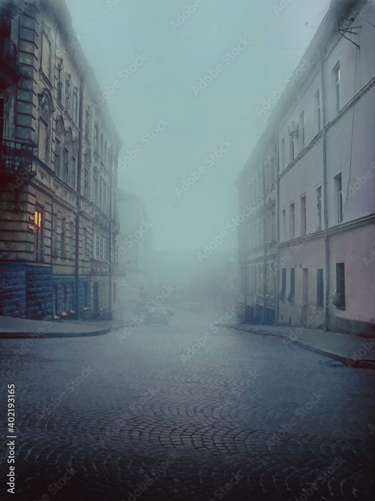 Old town in dense fog. Houses and a city street in a mystical fog ...
