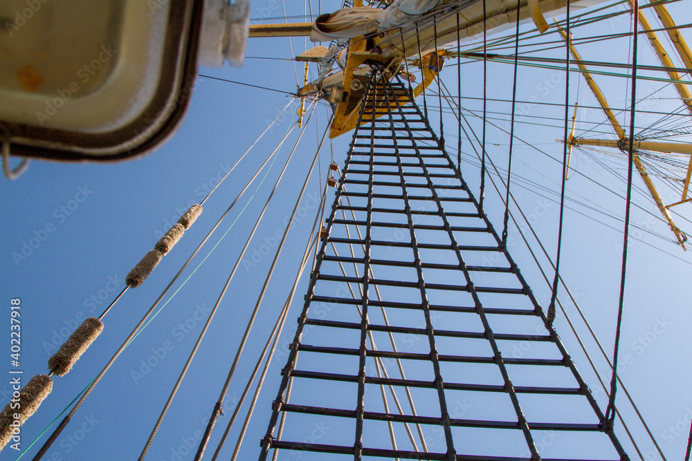 mast of a sailing ship against the sky. The sails have been removed ...