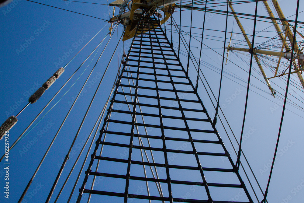 mast of a sailing ship against the sky. The sails have been removed ...