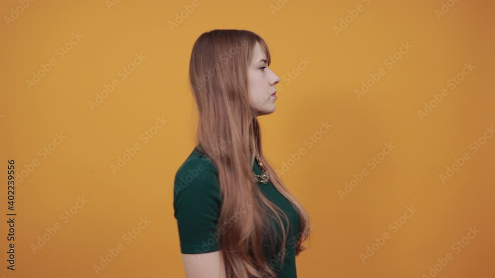 Side view of standing young beautiful watching. Rear view people ...