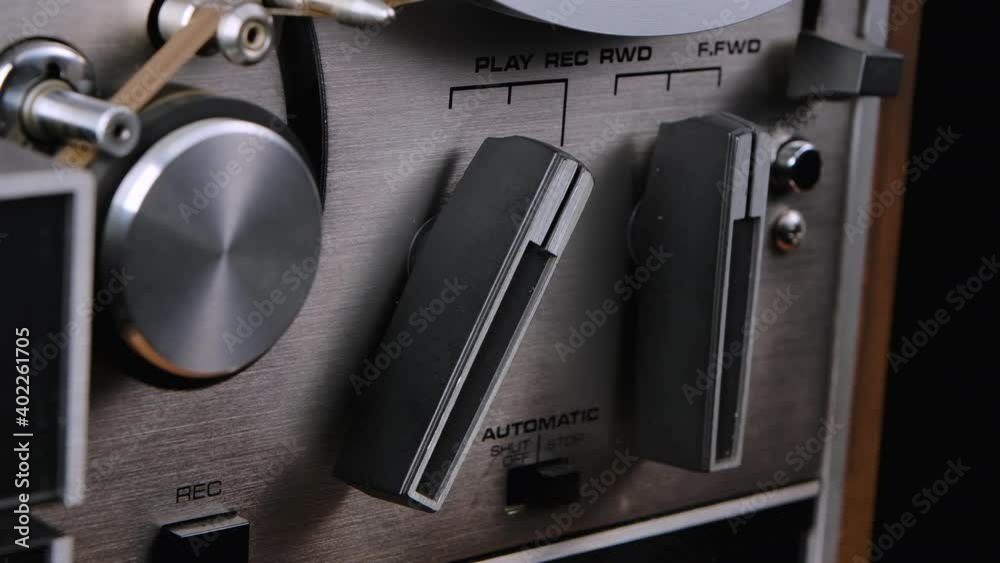 A man hands turn on and off vintage professional analog reel-to-reel ...