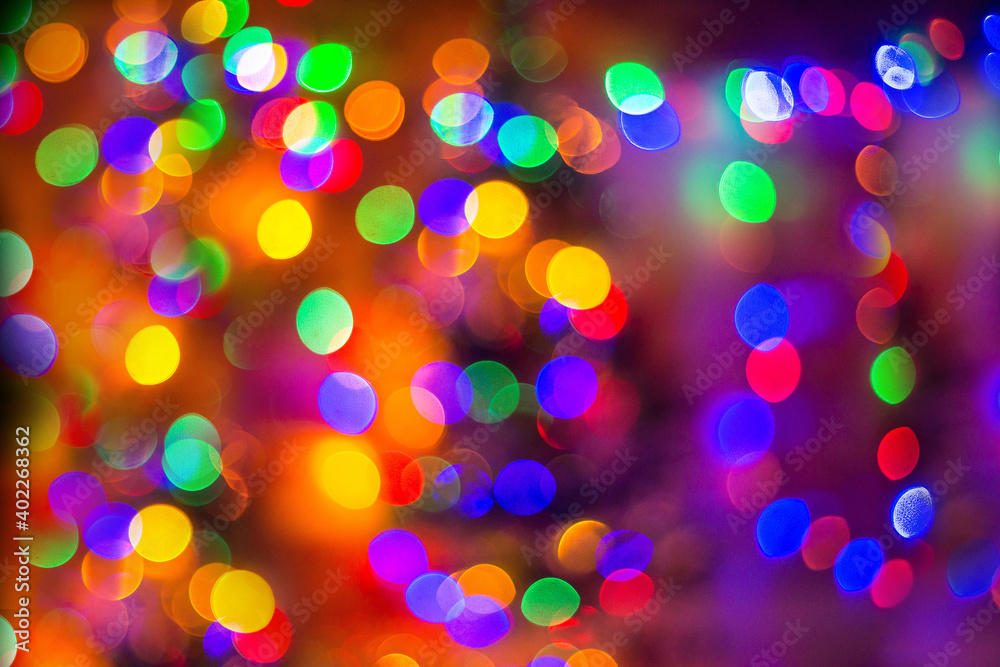 Colorful defocused bokeh lights in blur night background. cloud of multicolored particles in the ...