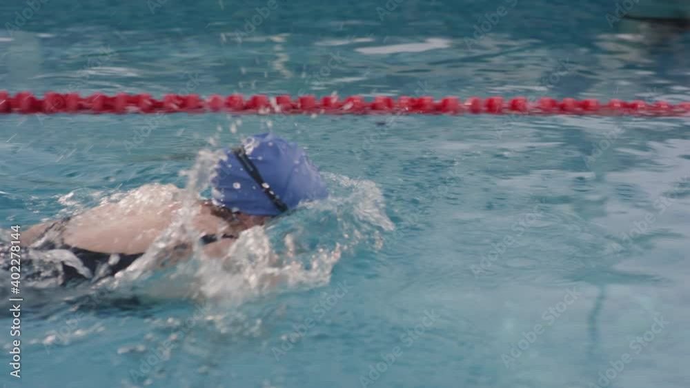 Slow Motion close up tracking shot of professional female swimmer in ...