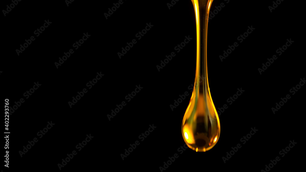 Pouring oil drop isolated on black background. Macro shot. Stock Photo ...