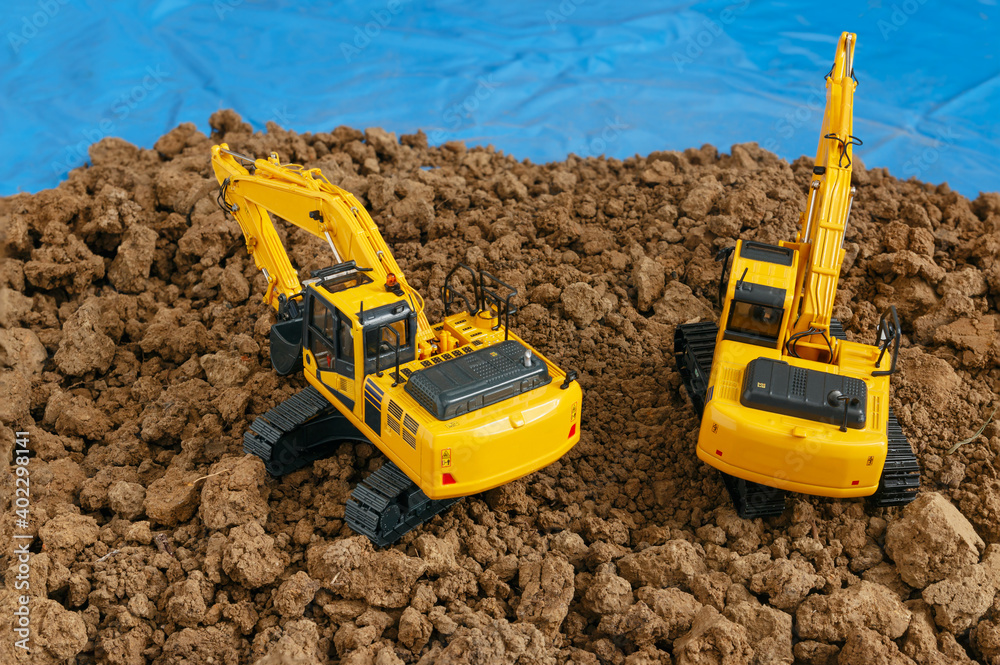 Two excavators loader are digging the soil in the construction site ...