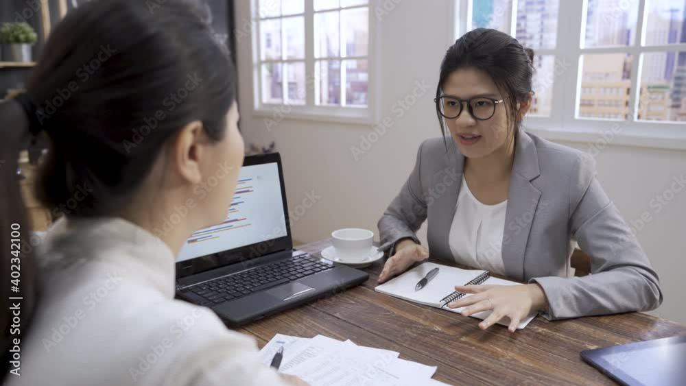 female team partners disagree on terms at meeting in cafe store. women ...