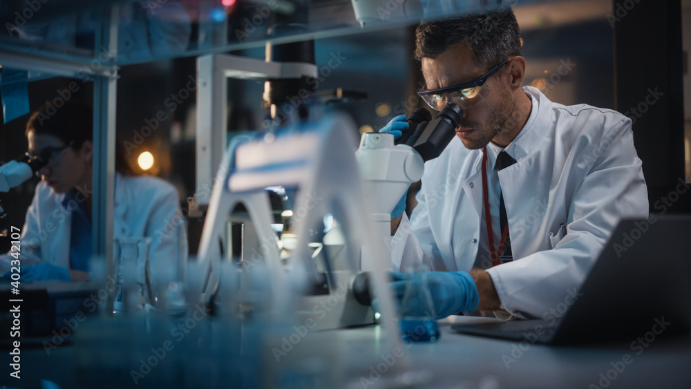 Modern Medical Research Laboratory: Male and Female Scientists Work on ...