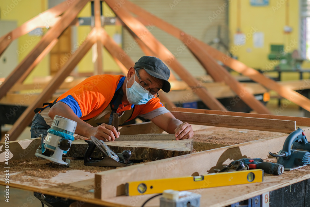 Front view photo of focused professional hardwood worker making slab coffee table use try square ...
