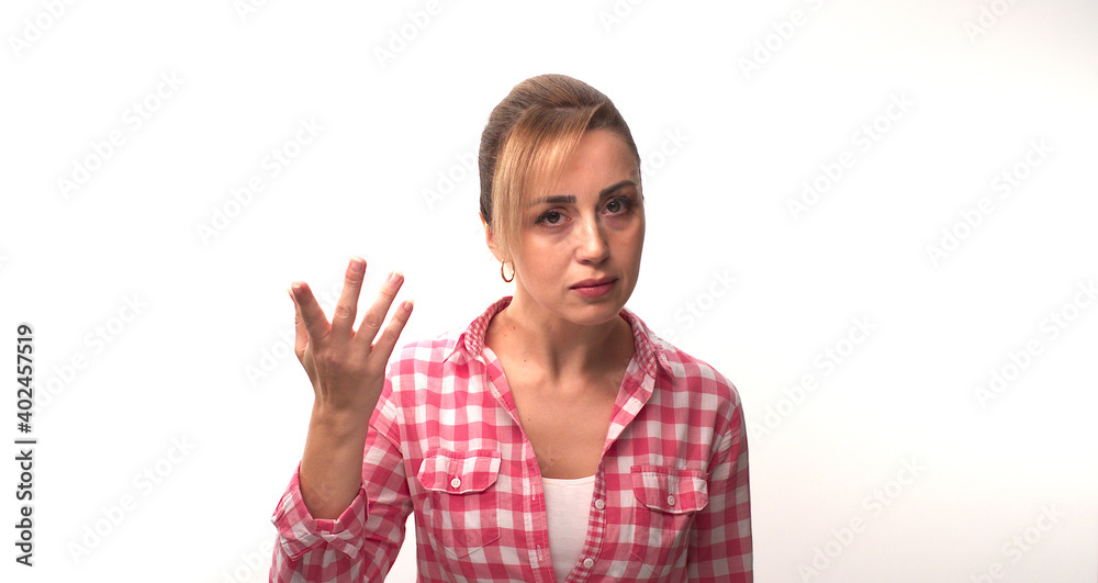 Hey you! Angry young woman with blonde hair pointing at the camera ...