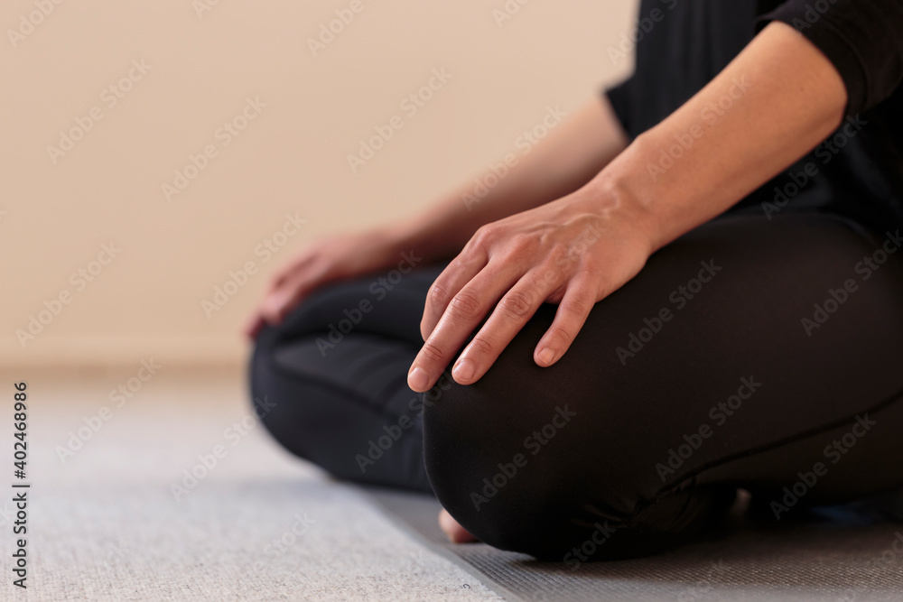 Horizontal side closeup of lower body of yogini on the floor with legs ...