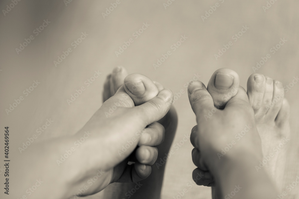 Detail of yogini making forward bending exercise on the floor, reaching ...