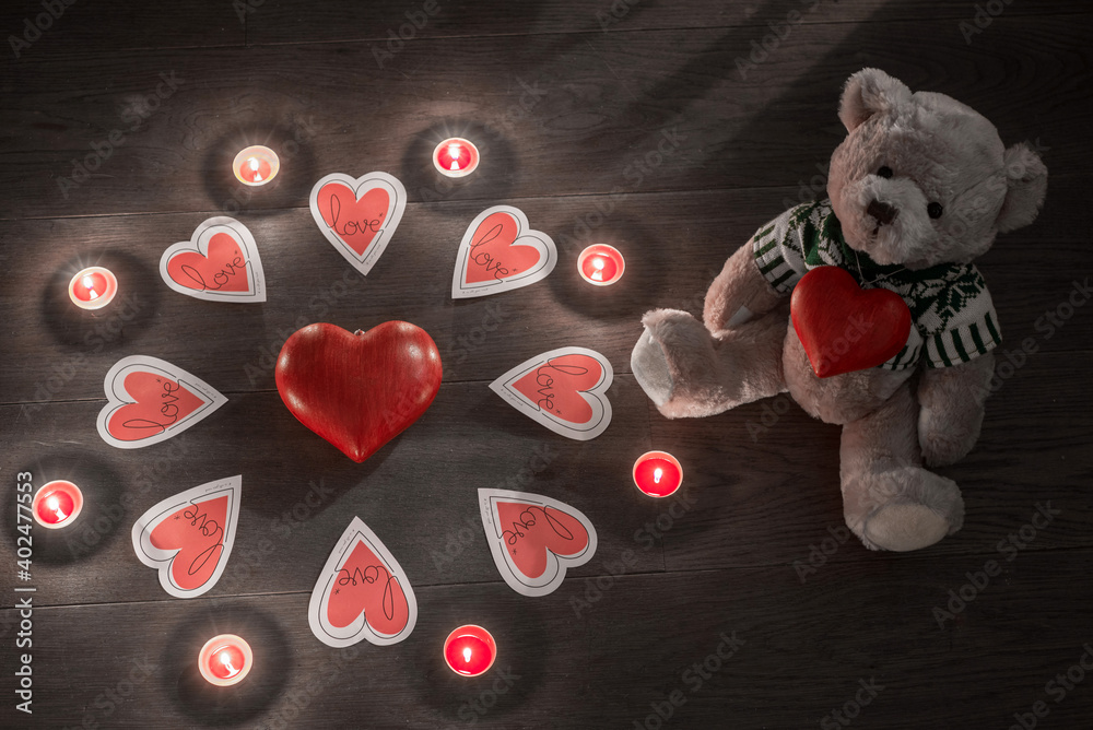 Red heart surrounded by eight paper hearts, eight burning candles, all ...