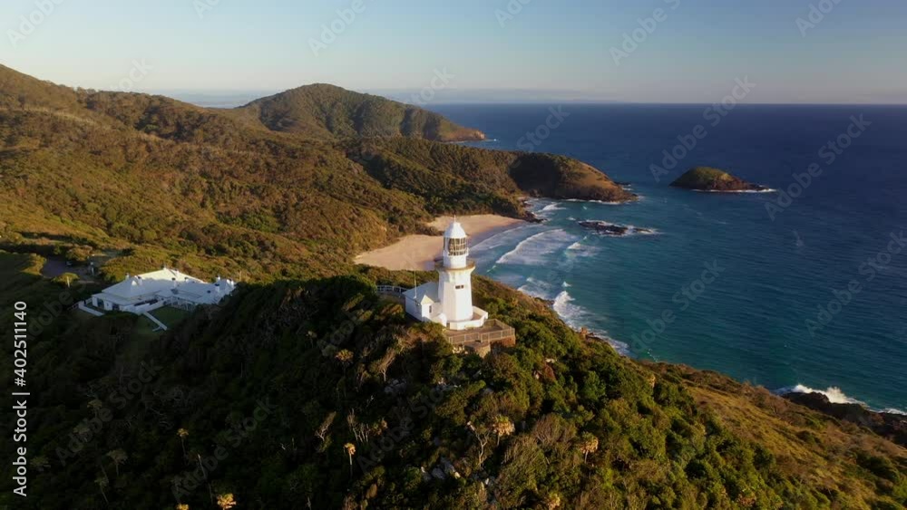 Wide cinematic drone shot rotating around Smoky Cape Lighthouse in ...
