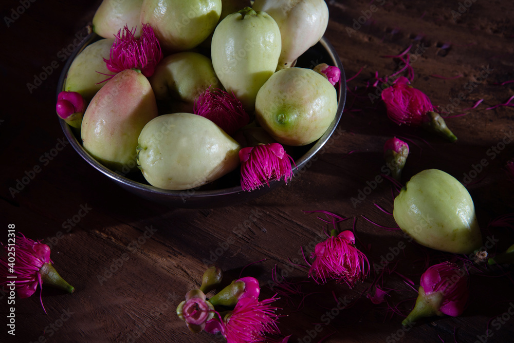 Beautiful pink Malay apple flowers and Malay apples on wooden table ...