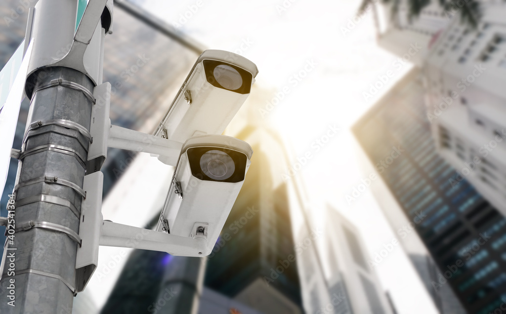 Modern public CCTV camera on electric pole with blur building ...