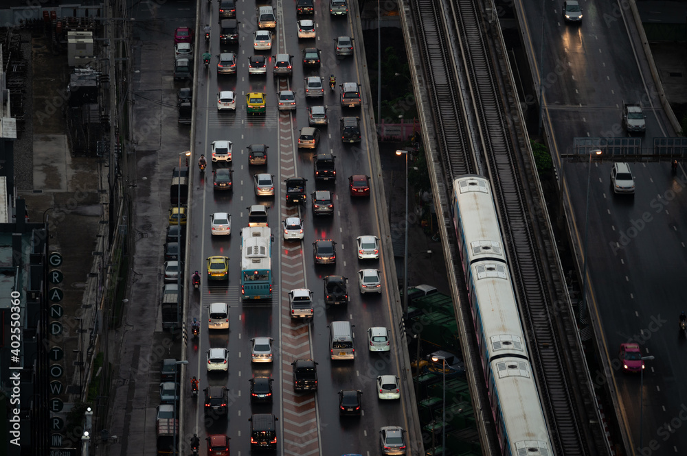 Skytrain on rail with traffic jam on highway in rainy day at BTS ...