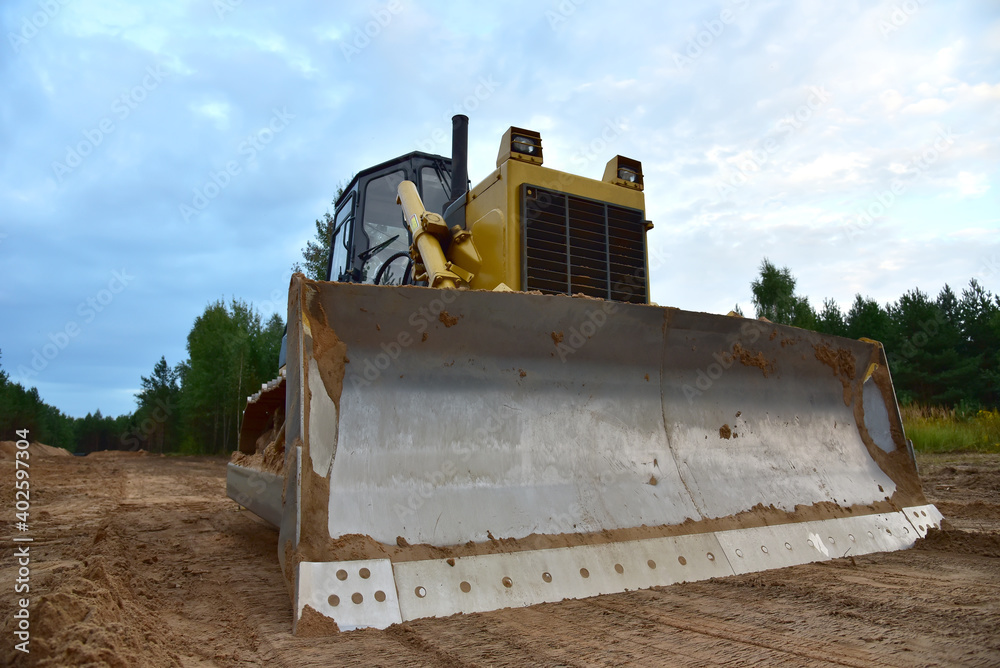 Dozer during clearing forest for construction new road . Yellow ...