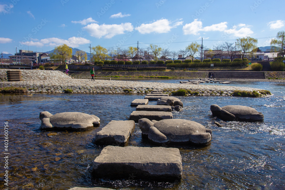 Amazing stones footpath throught river Katsura with statues of turtles ...