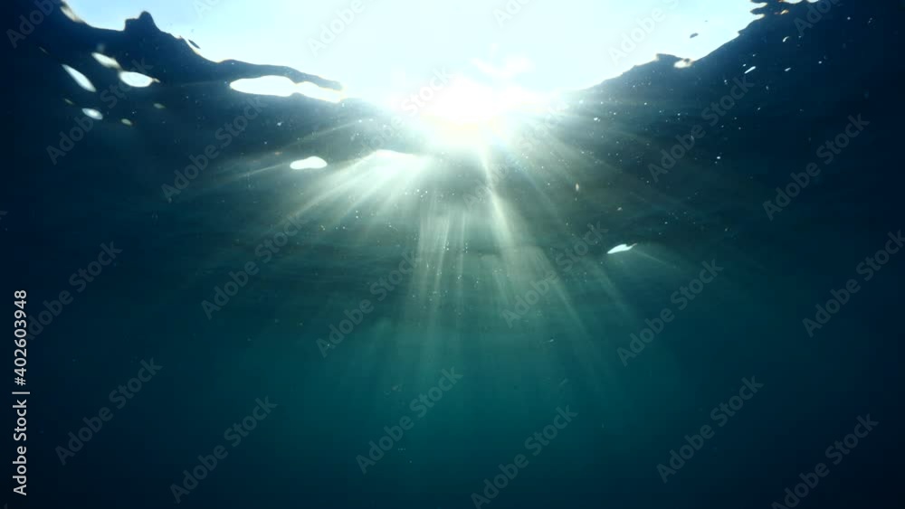sun ray and sun beam scenery underwater waves on surface of water slow ...