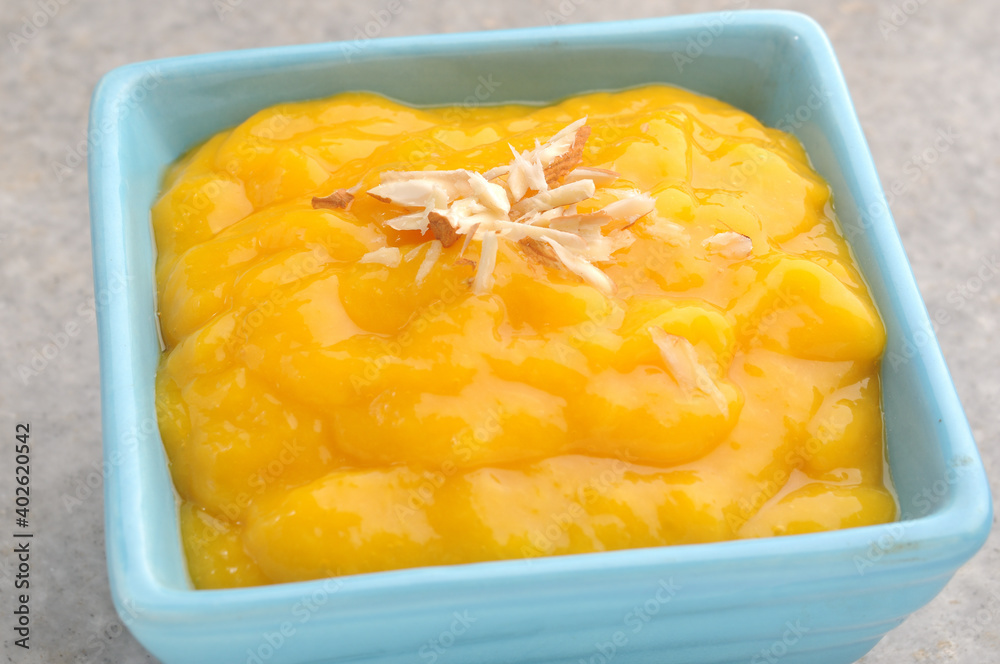 aam ras or mango pulp with almond topping, Indian traditional mango ...