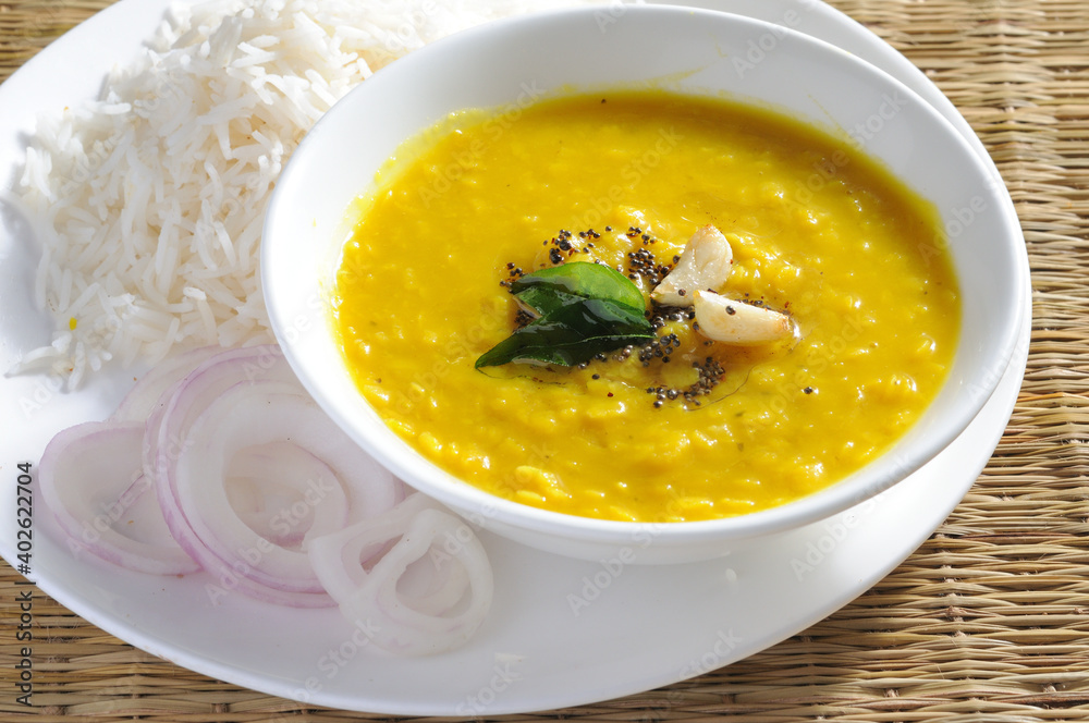 yellow daal or toor daal with tadka on top and white rice is every ...