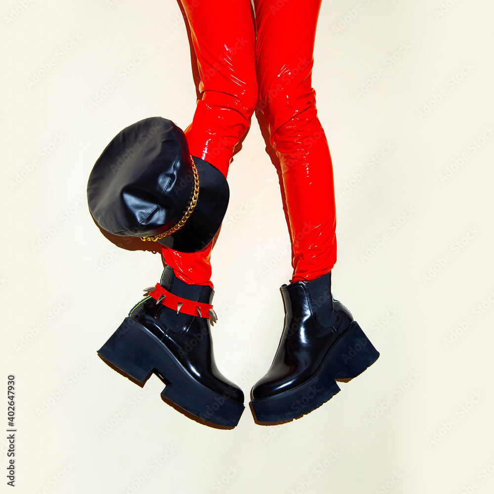 Fashion legs in platform party boots and red leather leggins and cap on ...