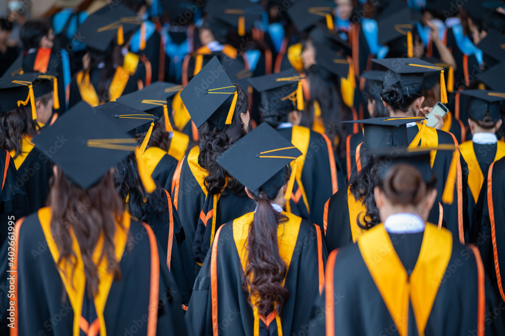 The back of the graduates are walking to attend the graduation ceremony ...
