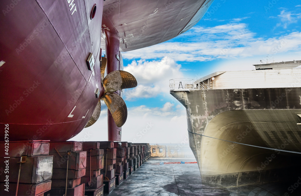 Propeller with rudder in floating dock yard, Under the hull in floating ...