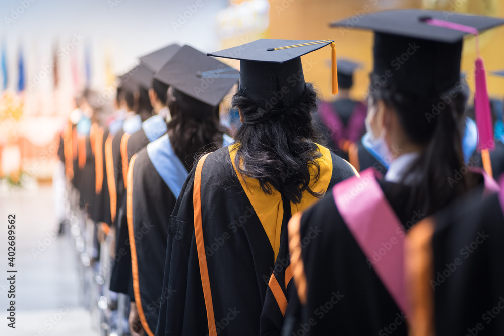 Rearview of the university graduates line up for degree award in ...