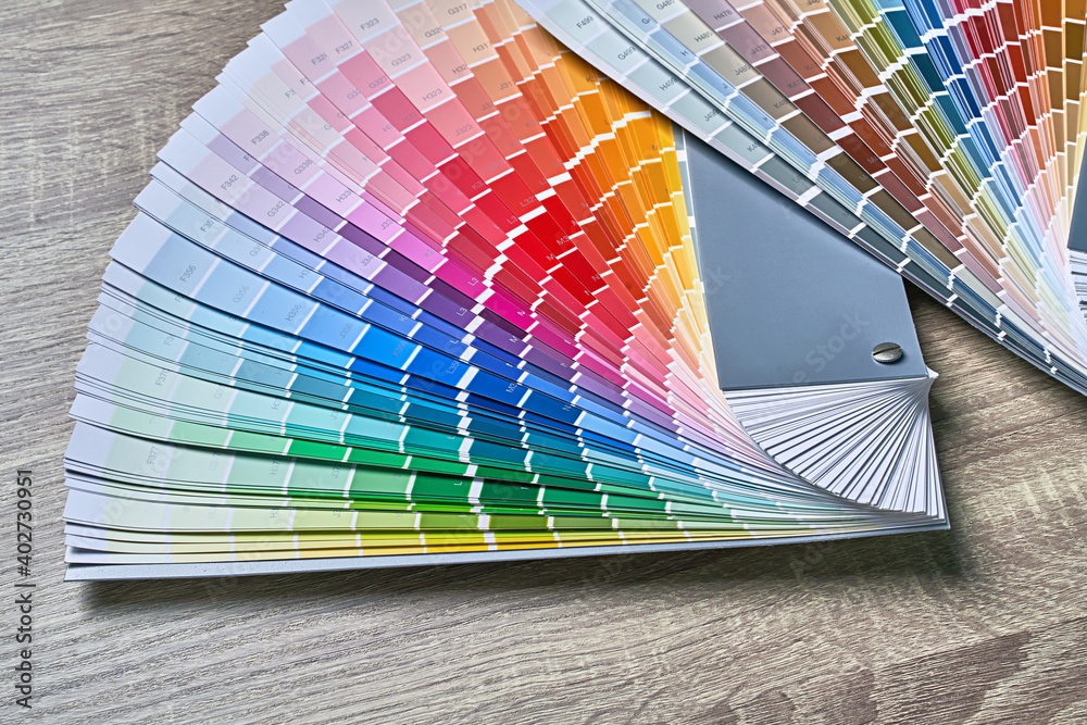 Color wheel palette for choosing paint tone. Various colors on wooden ...