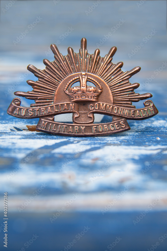 Vintage WW2 Australian army rising sun badge on textured blue. Stock ...