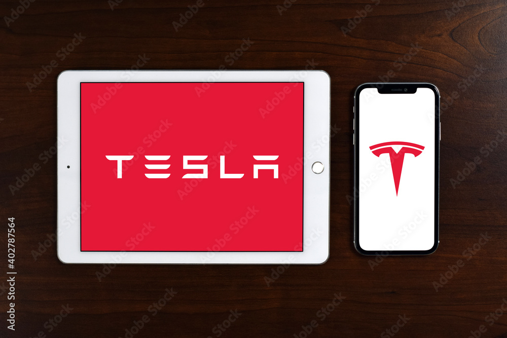 Tesla logo displayed in full screen on iPad or tablet and iPhone or ...