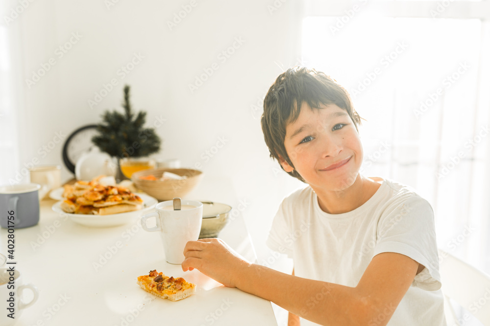 Preteen boy breakfast, portrait of smiling boy having breakfast at home ...