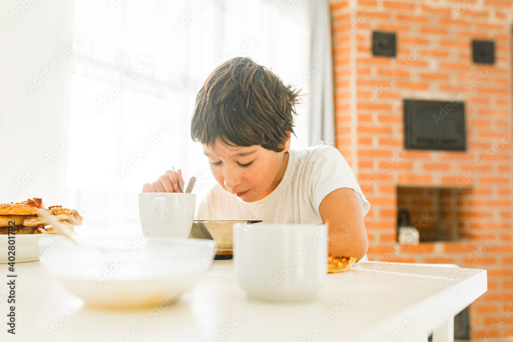 Preteen boy breakfast, portrait of smiling boy having breakfast at home ...