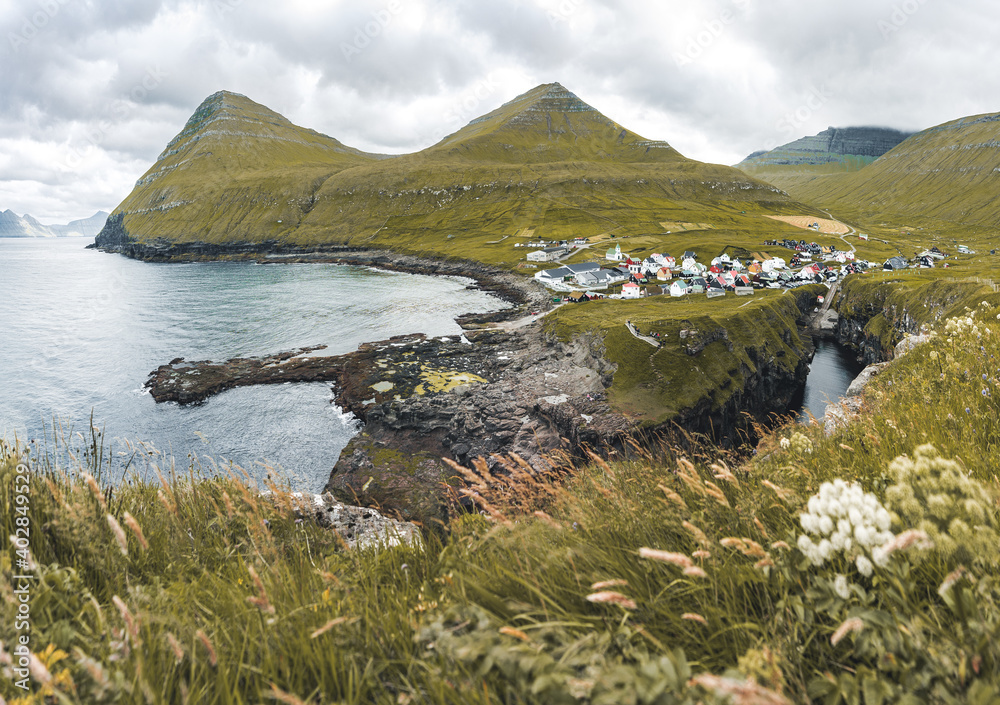 Faroe islands village of Gjogv or Gjov in Danish. Sea-filled gorge on ...