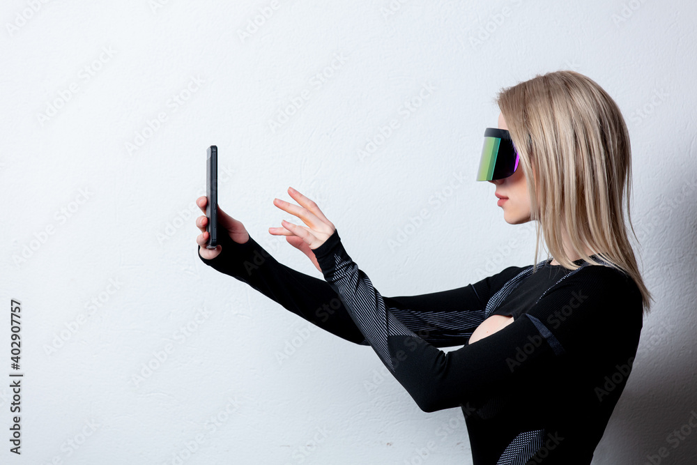 android female in VR glasses and mobile phone on white background ...