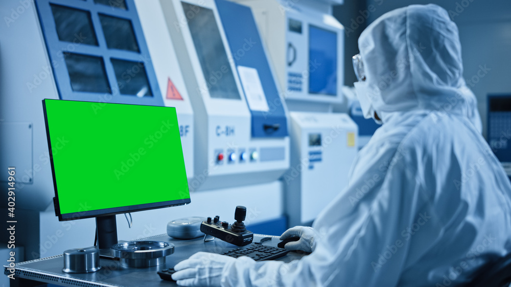 Factory Cleanroom: Engineer Wearing Coveralls Does System Control on ...
