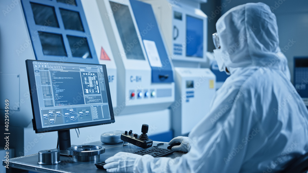 Factory Cleanroom: Engineer Wearing Coveralls Does System Control on a ...