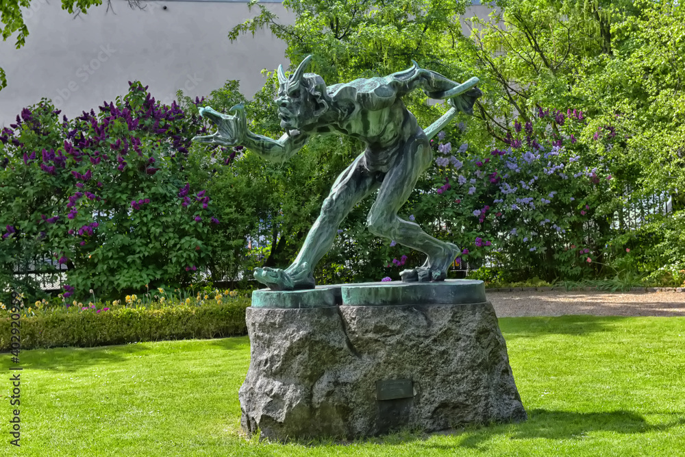 Bronze statue of demon in park in front of Ny Carlsberg Glyptotek, an ...