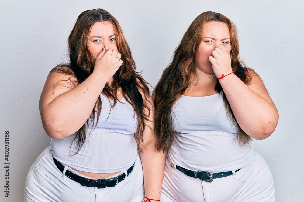 Plus size caucasian sisters woman wearing casual white clothes smelling ...