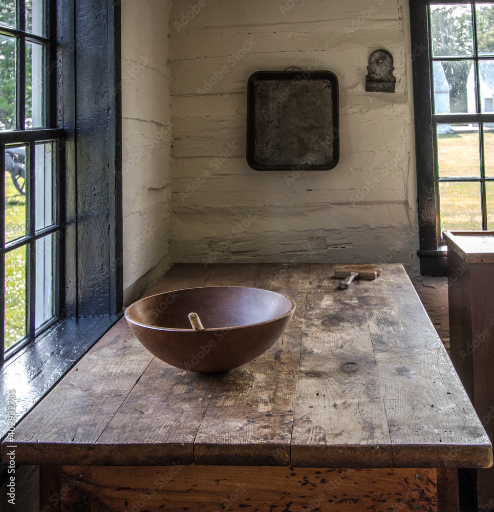 Simple rural farmhouse kitchen with wooden table and bowl in vertical ...