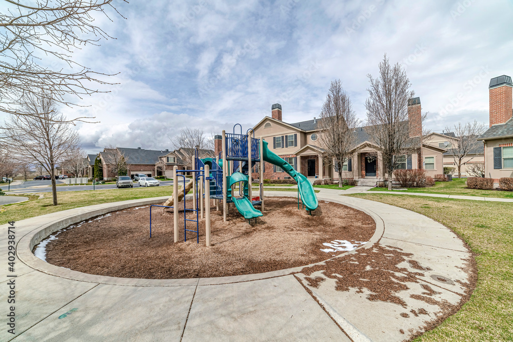 Childrens playground and circular pathway at a park in teh neighborhood ...