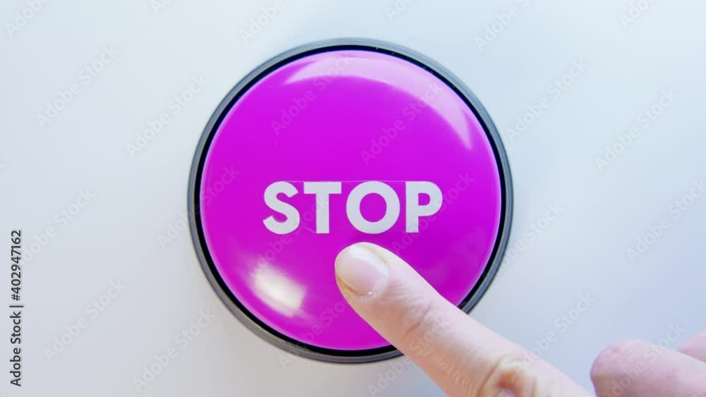 Woman pushing a Stop button, close up. Finger pressing button to pause ...