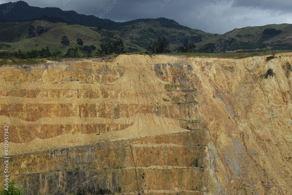 Open cast mine with huge clay wall and moody sky overhead Stock Photo ...