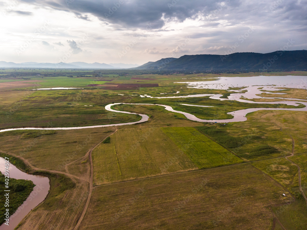 Scenic landscape aerial view of field river and basin against a natural ...