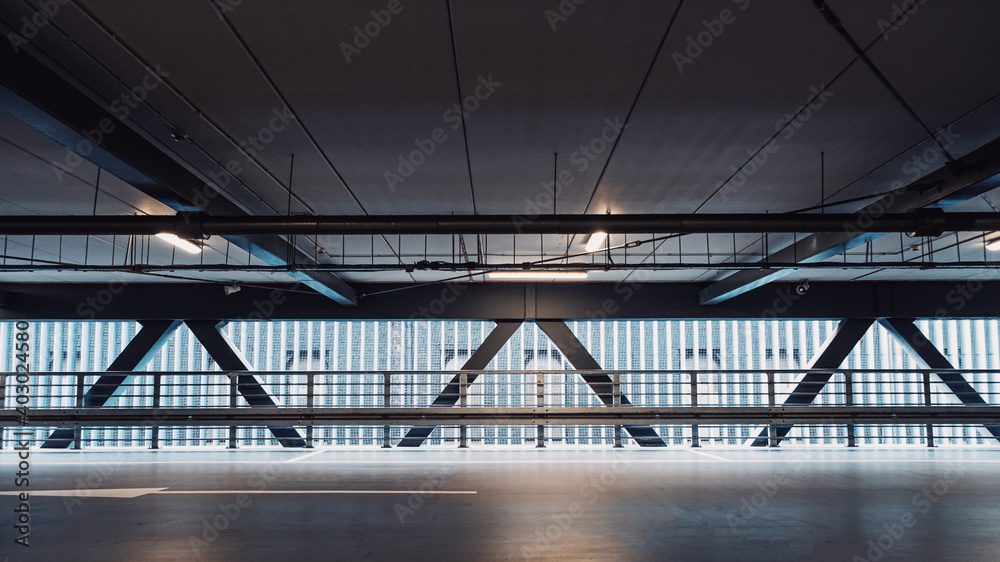 Interior of a modern multi-storey car park. Metal concrete structure ...