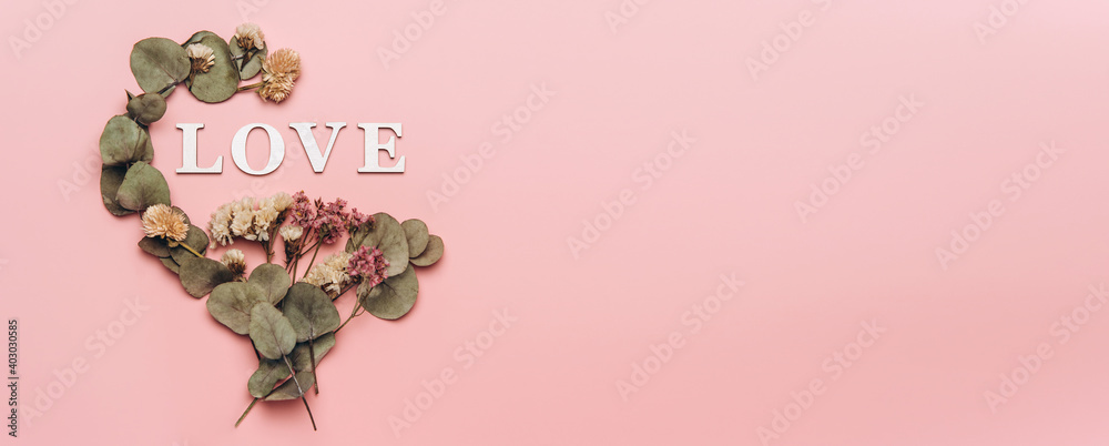 Creative flat lay of word love on soft color background with natural ...
