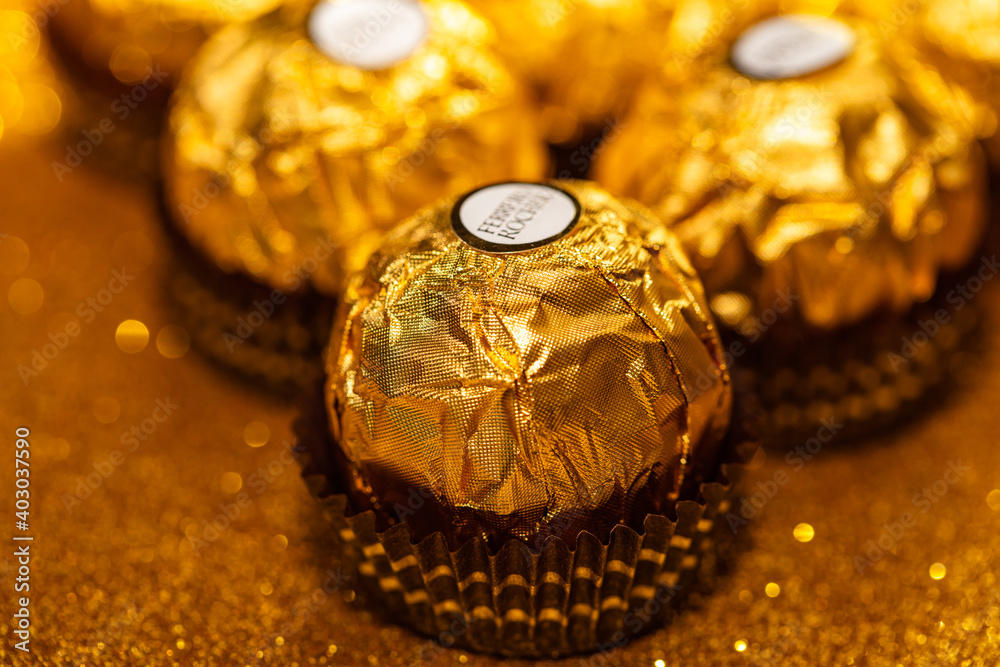 Ferrero Rocher premium chocolates on golden glitter background Stock ...